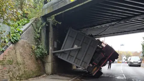 Lorry wedged under Warwick railway bridge after crash