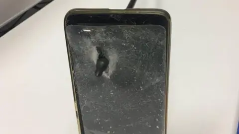 Australian man blocks arrow with mobile phone
