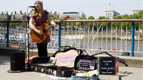 Busking goes cashless with 'a world first' for London - BBC News
