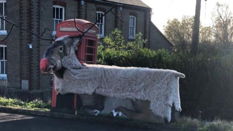 Rudolph the red phone box reindeer honours delivery drivers - BBC News