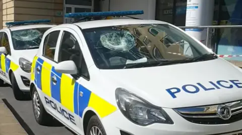 Arrest after police cars smashed outside Bath station