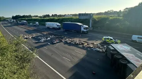 M40: Motorway reopens after sausages scattered in lorry crash