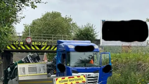 Stoke-on-Trent: Road shut after lorry toppled in bridge strike