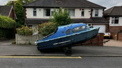 Search for owner of boat left on Stoke-on-Trent street