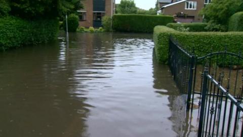 Hundreds of homes flooded as downpours continue - BBC News