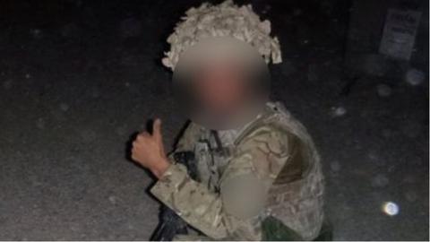 Pictures appear to show RAF man posing with dead Taliban fighter - BBC News