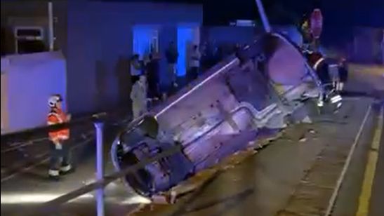 Crash leaves car dangling over Jersey railing - BBC News