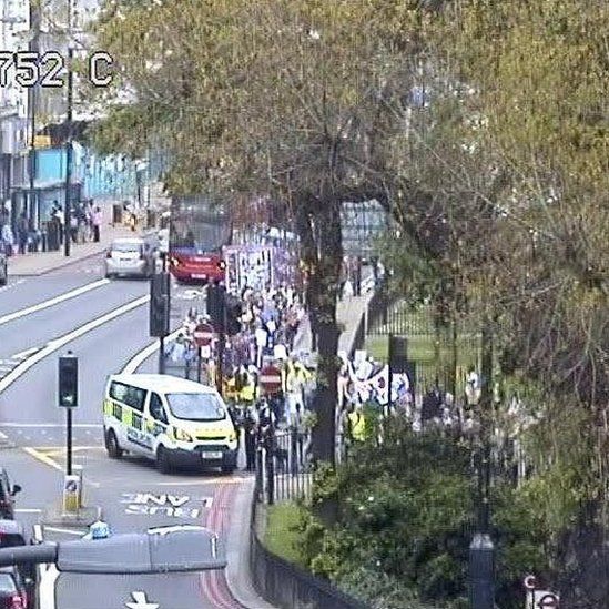 Hundreds protest against Lewisham library cuts - BBC News