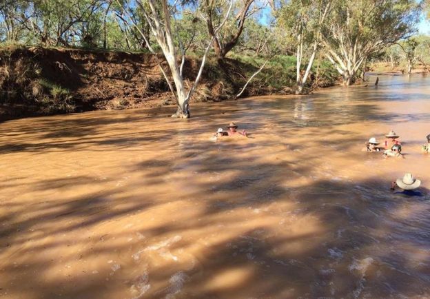 Officer films glee as dry Australia river starts to flow - BBC News