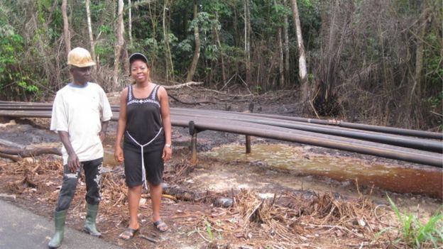 The Nigerian woman cleaning up a land soaked in oil - BBC News