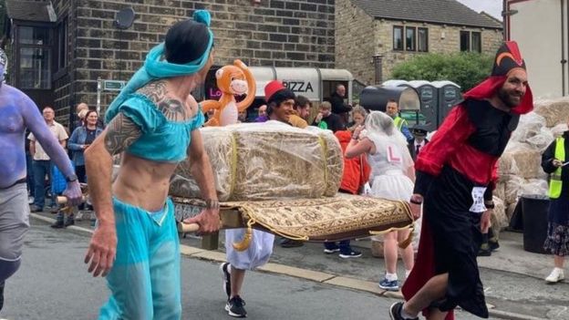 Oxenhope Straw Race: Pints and perspiration at annual bale race - BBC News