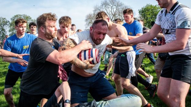 Hallaton Bottle Kicking: Villages compete in bruising tradition - BBC News