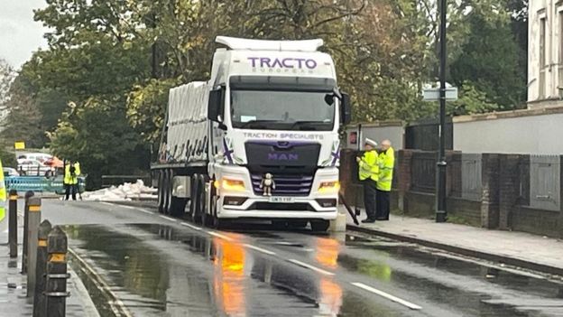 Woman struck by HGV's brick load remains in critical condition - BBC News