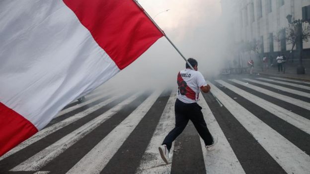 Peru: Police clash with protesters in capital Lima - BBC News