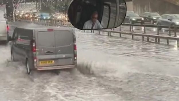 UK weather: Heavy rain floods London Tube stations and roads - BBC News