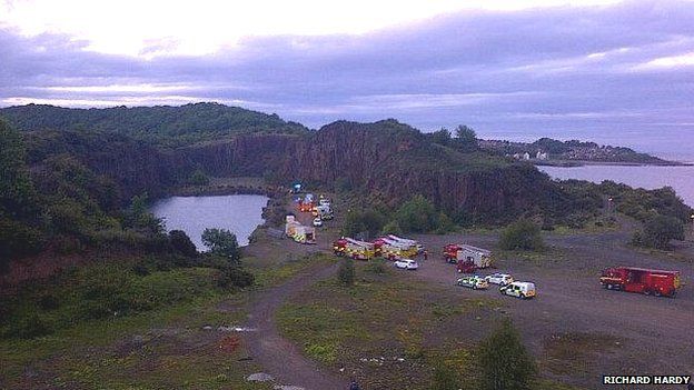 Divers find body after quarry search for teenager - BBC News