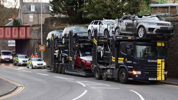 Luxury cars crushed as transporter hits low bridge in Perth - BBC News
