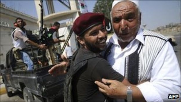 Libyans celebrate their freedom as they mourn the dead - BBC News