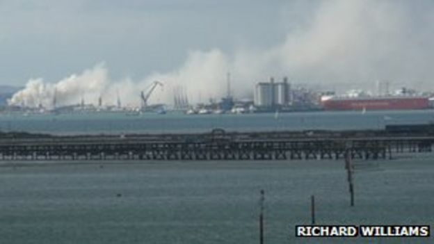 Dock fire dies down helped by wind and heavy rain - BBC News