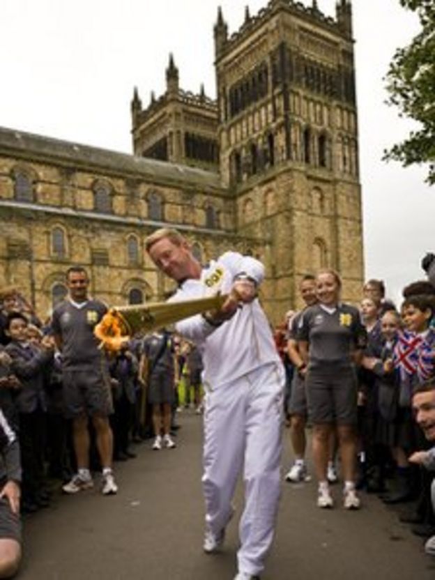 Olympic torch: Boy continues after fall with torch - BBC News