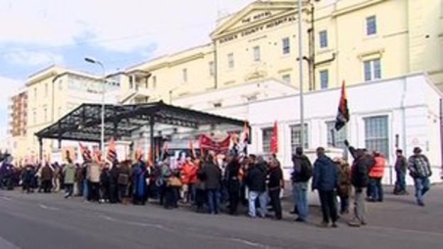 Protesters gather in Brighton for NHS cuts demo - BBC News