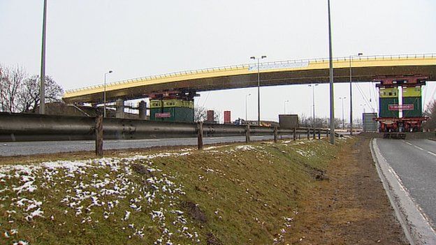 Trouble-hit Golden Bridge installed over A9 in Inverness - BBC News