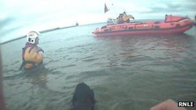 Blyth lifeboat crews rescue dog swimming out to sea - BBC News