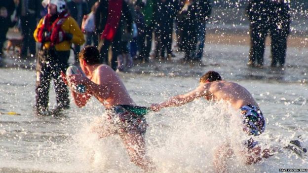 Hundreds brave boxing day dips in North East - BBC News
