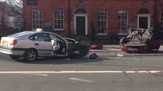 Manchester city centre crash car lands on roof - BBC News