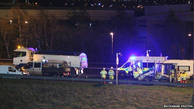 Road worker dies after being hit by reversing lorry on M8 - BBC News