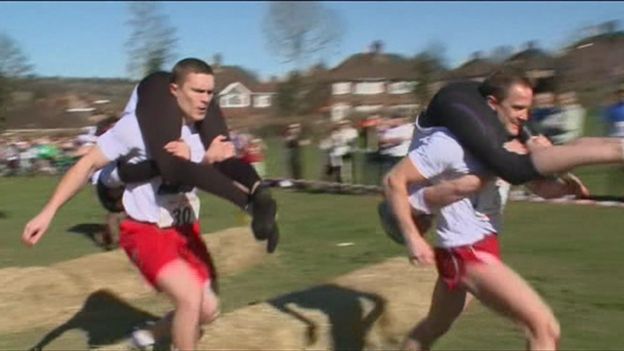 UK wife-carrying contest takes place in Dorking - BBC News