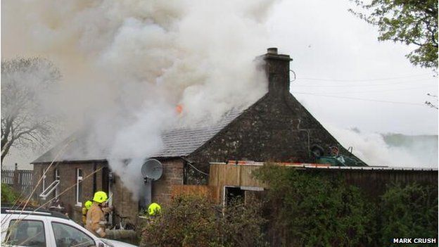 Dozens of firefighters called to Angus cottage blaze - BBC News