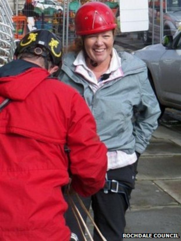 Woman completes clock tower abseil on wedding day - BBC News