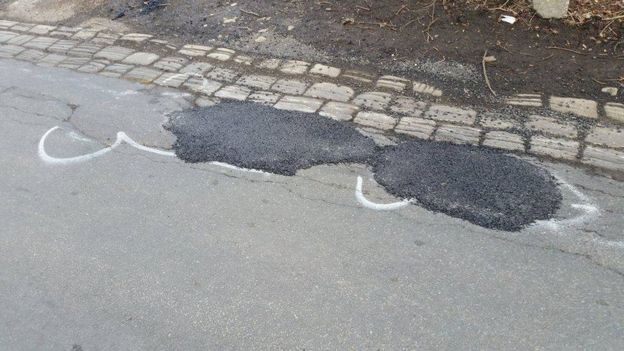 Mystery artist highlights Bury potholes with penis drawings - BBC News