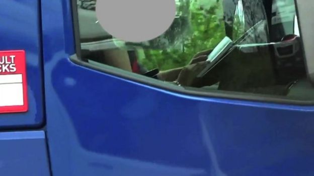 Lorry driver filmed reading book while driving along M60 - BBC News