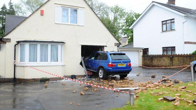 Car drives through garden wall and into house in Cardiff - BBC News