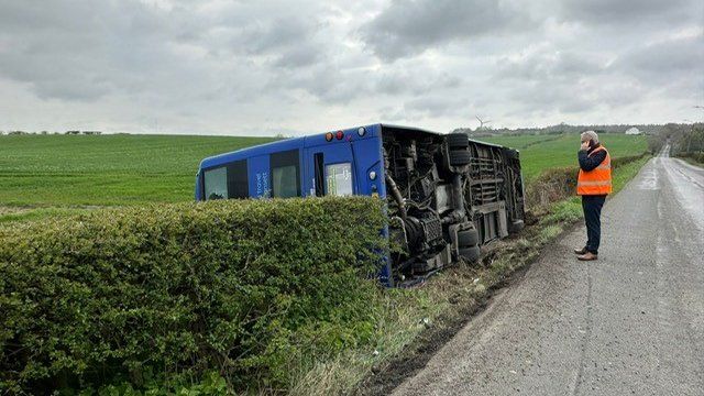 Bus driver suspended after double-decker overturns in Stanley - BBC News