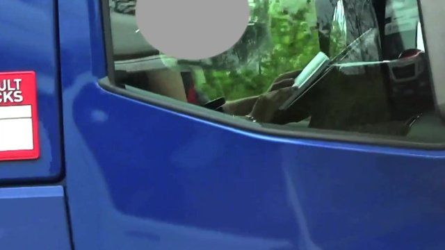 Lorry driver filmed reading book while driving along M60 - BBC News