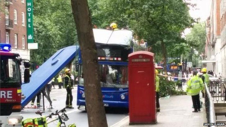 Four injured after roof is ripped off London tour bus - BBC News