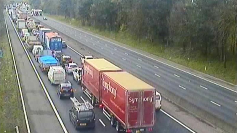 M1 crash leaves lorry hanging off bridge - BBC News