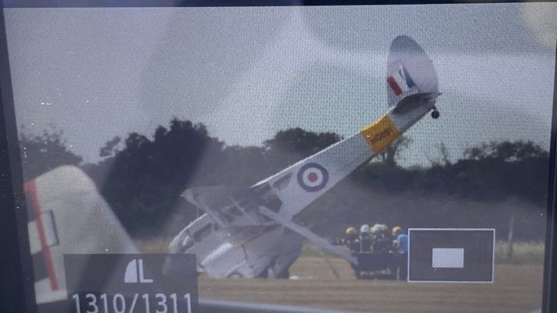 Duxford: Nine rescued as plane ends up nose down after landing - BBC News