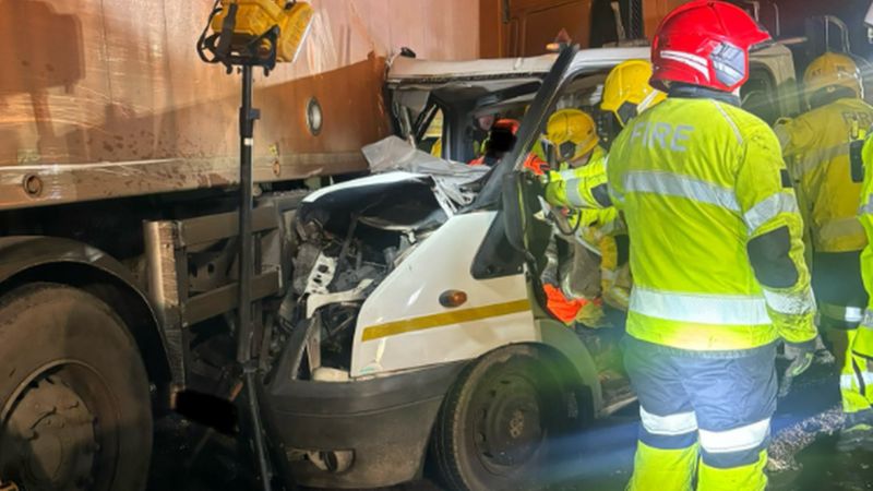 Driver trapped after crashed van gets stuck under lorry - BBC News