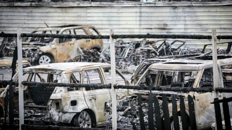 Cars destroyed in fire at Stockport Land Rover showroom - BBC News