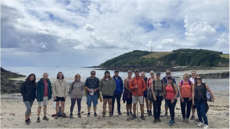 NHS staff mark 75 years milestone with coastal walk - BBC News