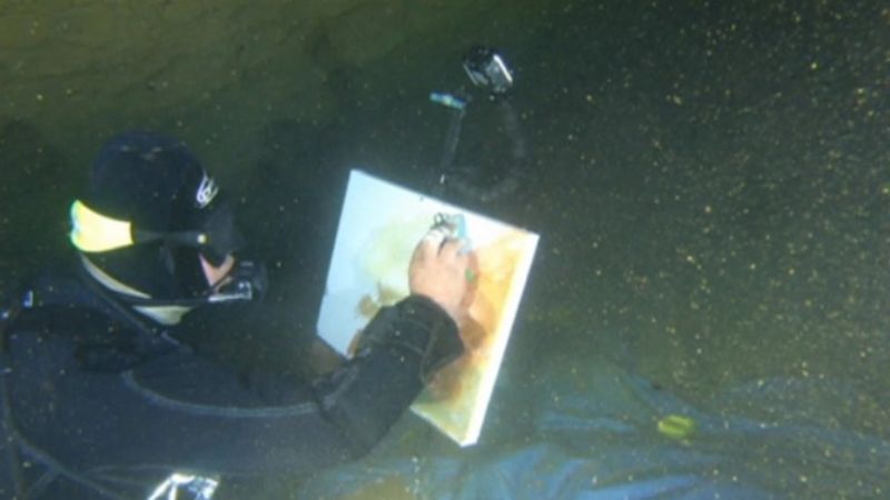 Wookey Hole: Artist paints canvas underwater in cave - BBC News