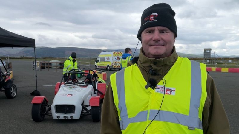 Charity track day enables blind people to drive racing cars - BBC News