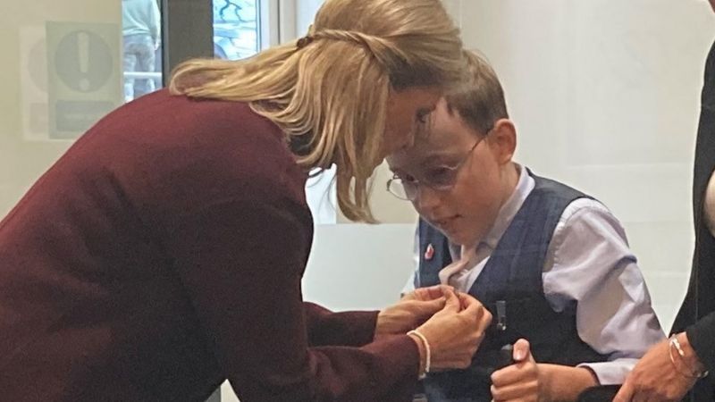 Captain Tobias: Youngest-ever Honours recipient receives award - BBC News