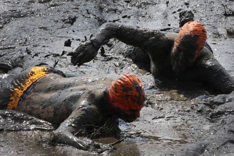 Germany Mud Olympics: Competitors get caked at annual event - BBC News