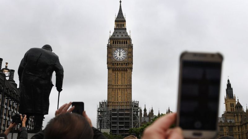St George's Cross back on Big Ben after renovation - BBC News