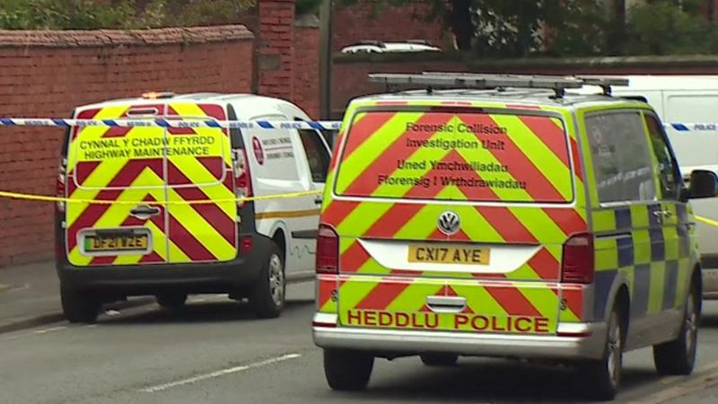 Wrexham crash: Driver held after doorman left seriously injured - BBC News